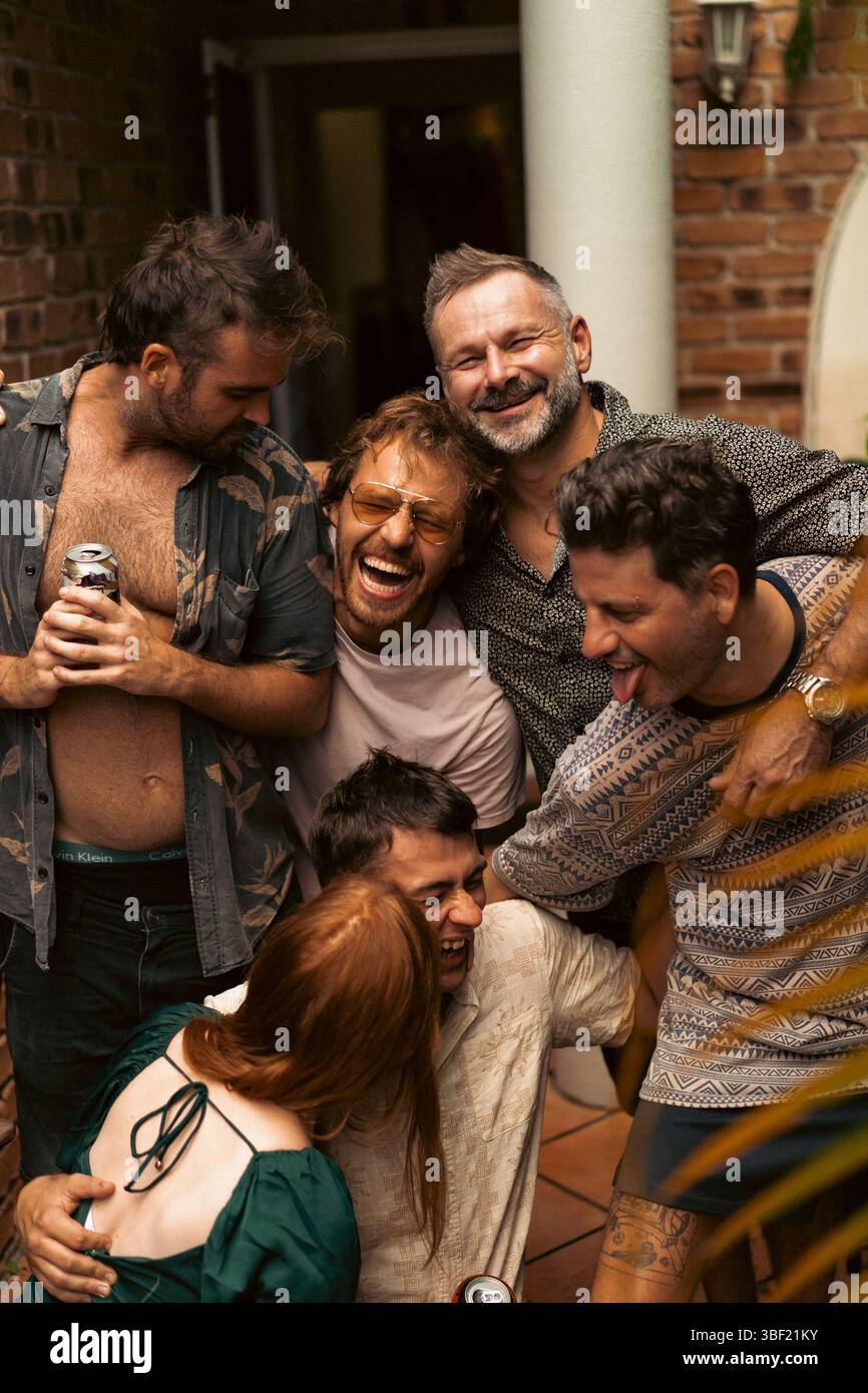 Group of friends laughing and sharing a joyful moment at a party Stock ...