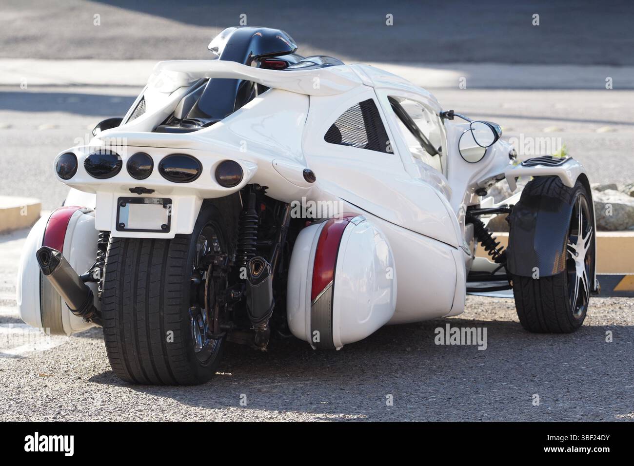 White trike three-wheeled vehicle autocycle parked on the street during ...