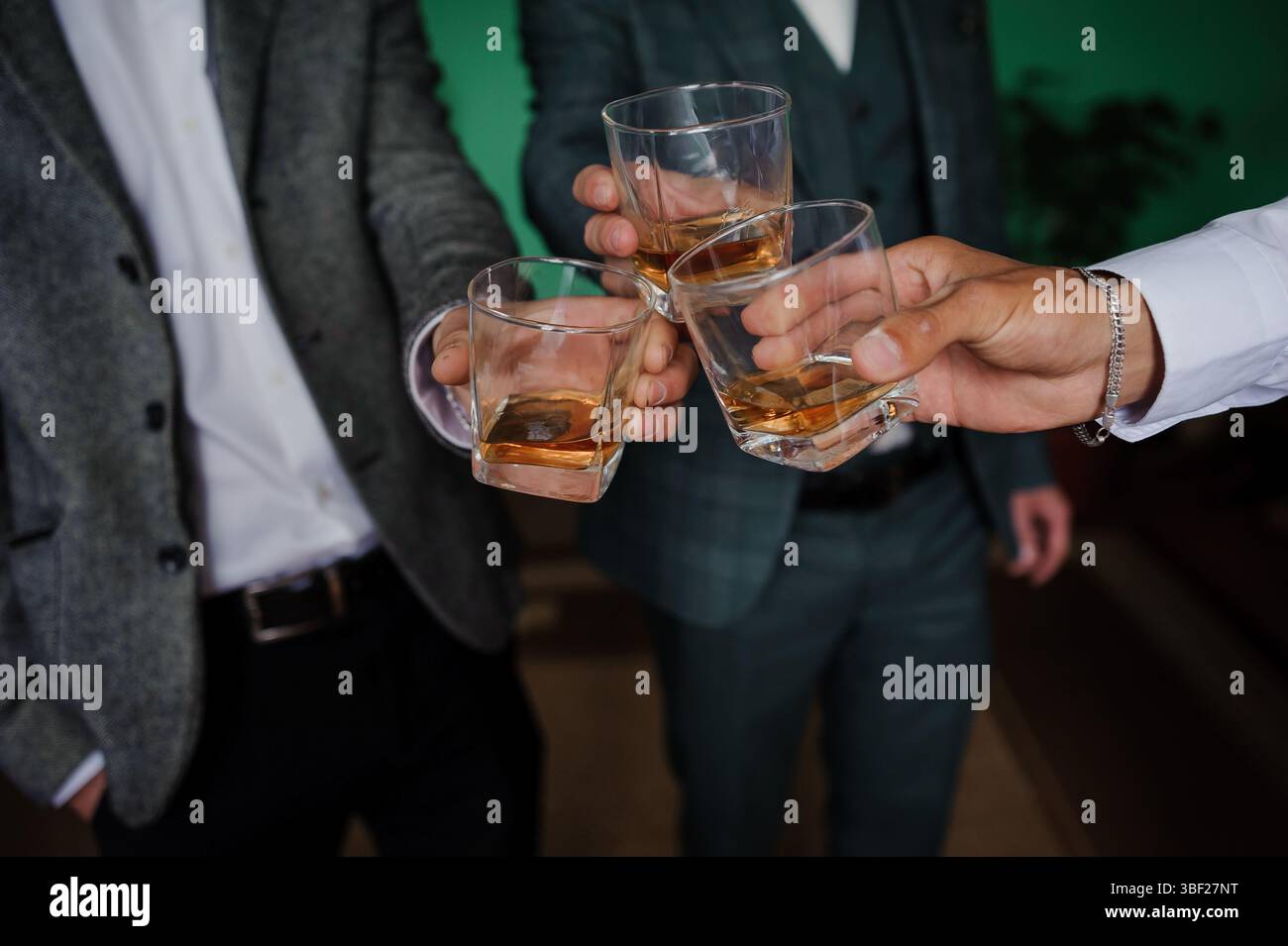 A close-up shot depicts three men, seemingly in their thirties or ...