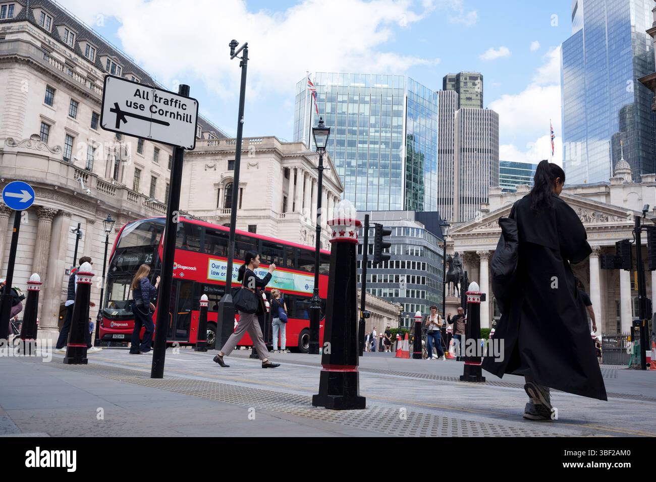 With the Bank of England on the opposite side of the road, City workers ...