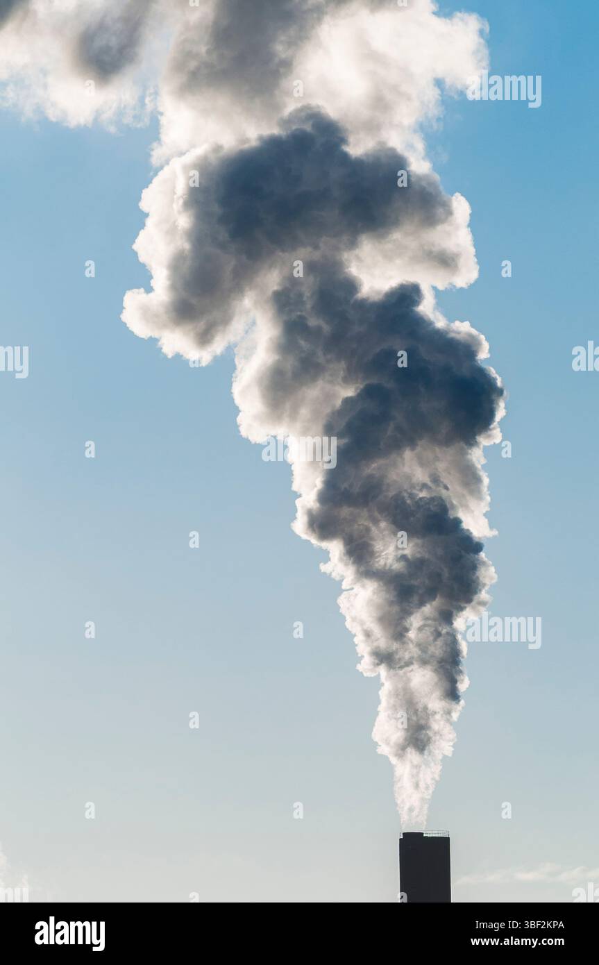 Tall industrial smokestack releases plumes hi-res stock photography and ...