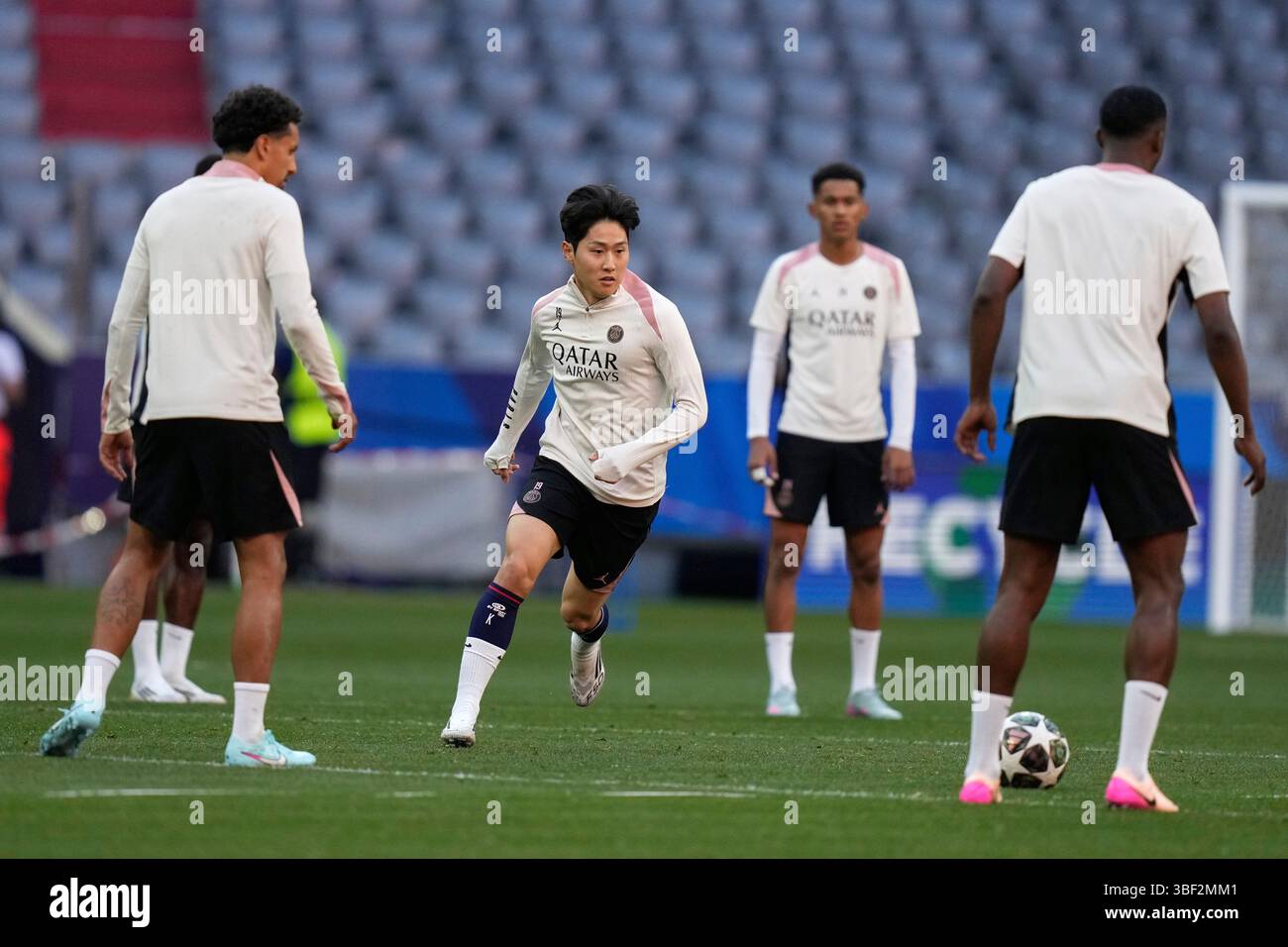 PSG's Lee Kang-in follows the ball during a training session ahead of ...