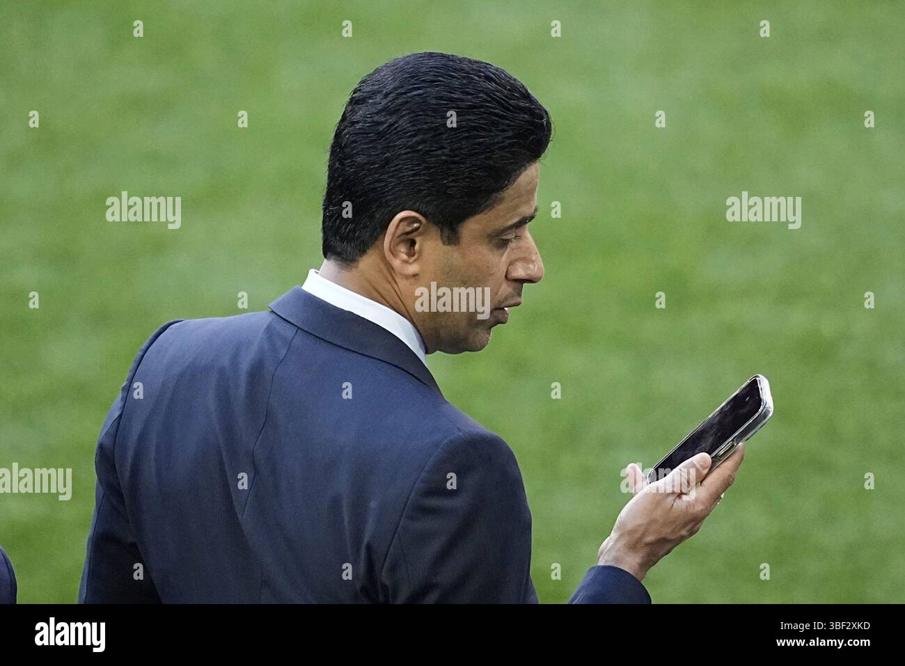 PSG president Nasser Al-Khelaifi checks his mobile phone during a ...