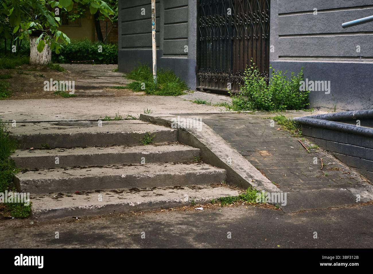Concrete steps with a ramp near a residential building, elements of ...