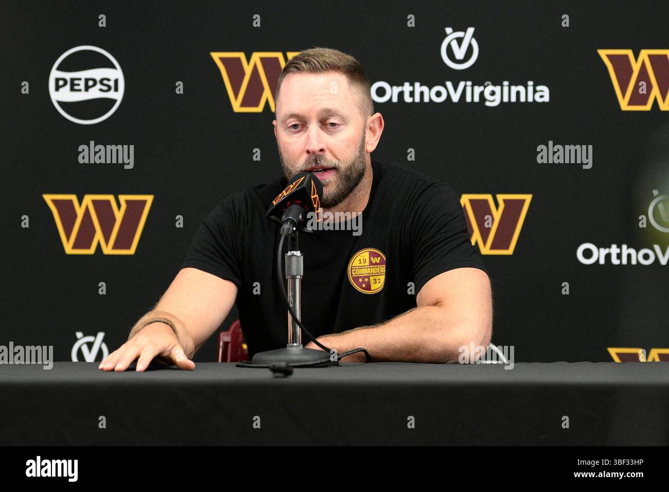 Washington Commanders offensive coordinator Kliff Kingsbury talks to ...
