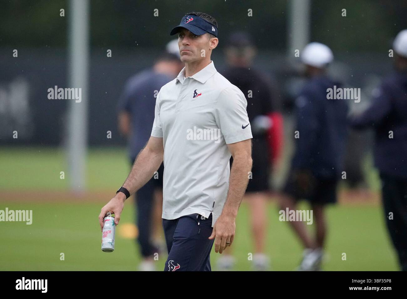 Houston Texans general manager Nick Caserio stands on a field during ...