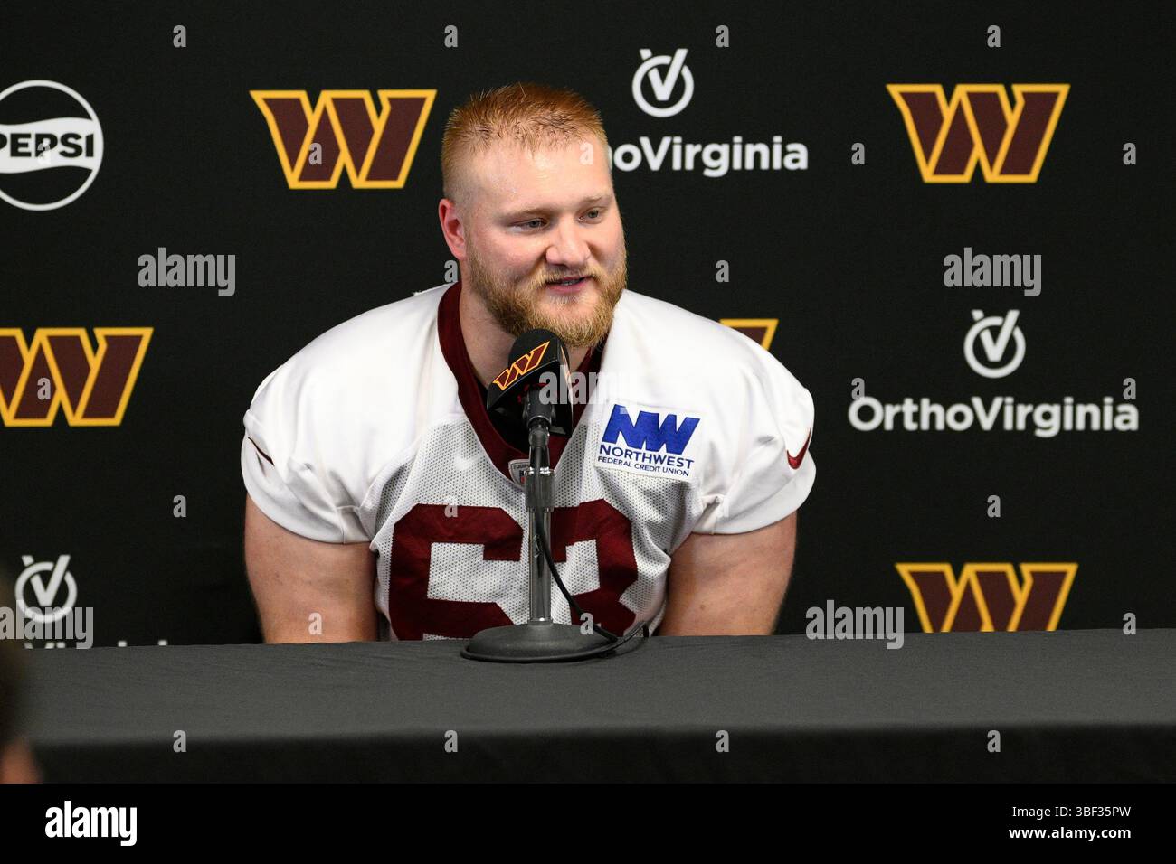 Washington Commanders center Tyler Biadasz (63) talks to the media ...
