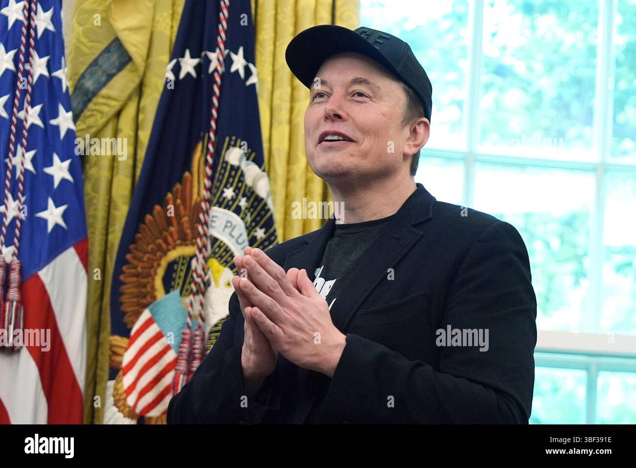 Elon Musk gestures as he speaks during a news conference with President ...