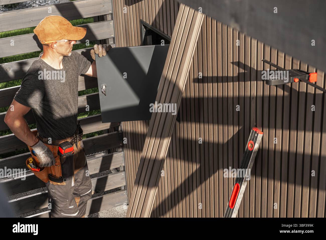 Construction worker carefully fitting hi-res stock photography and ...