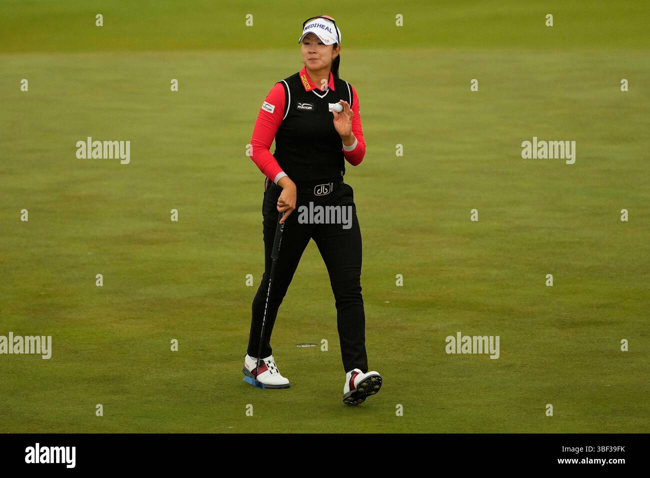 A Lim Kim, of South Korea, reacts after her putt on the second hole ...