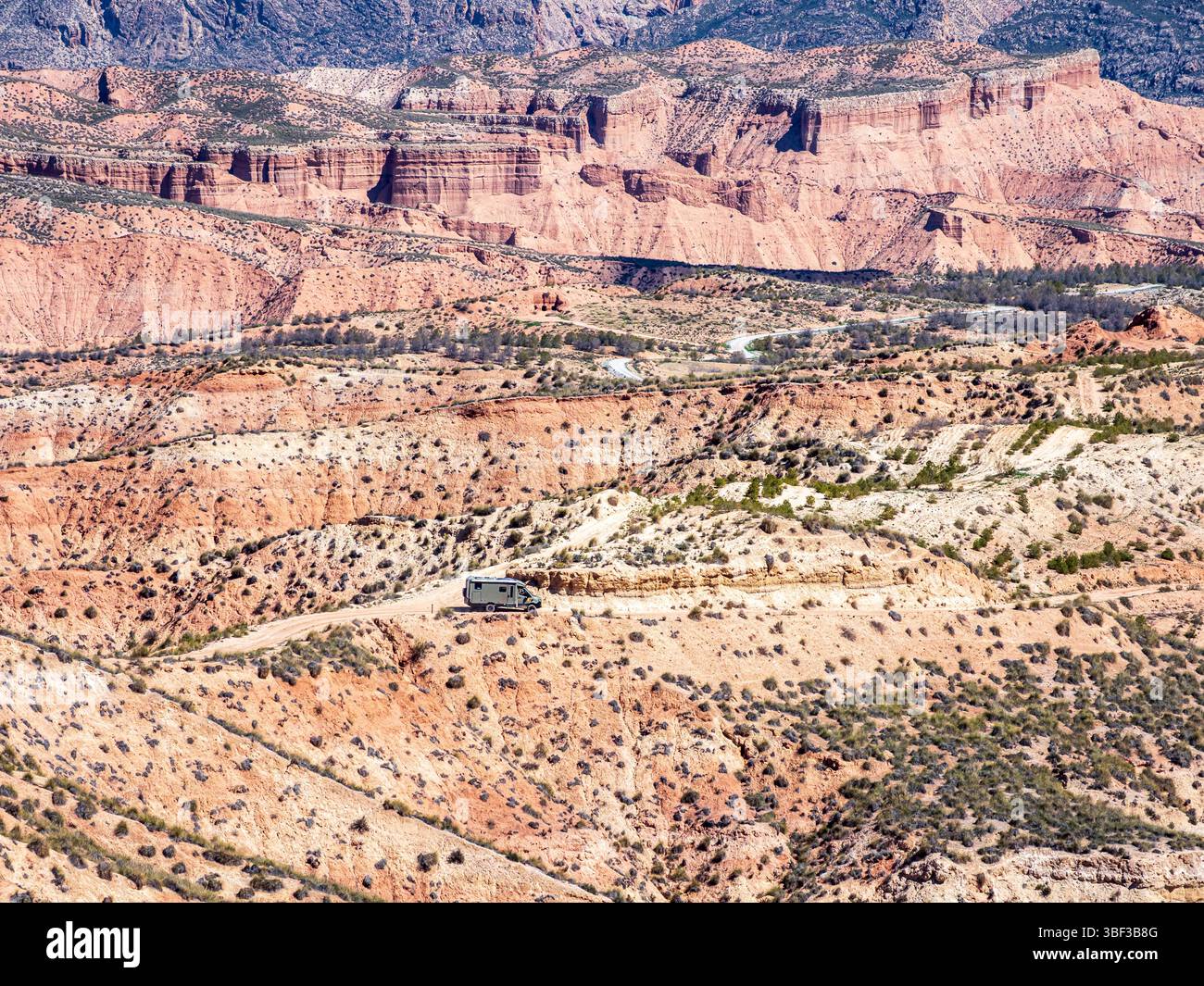 4x4 camper van driving on gravel road, Gorafe desert, colorful canyons ...
