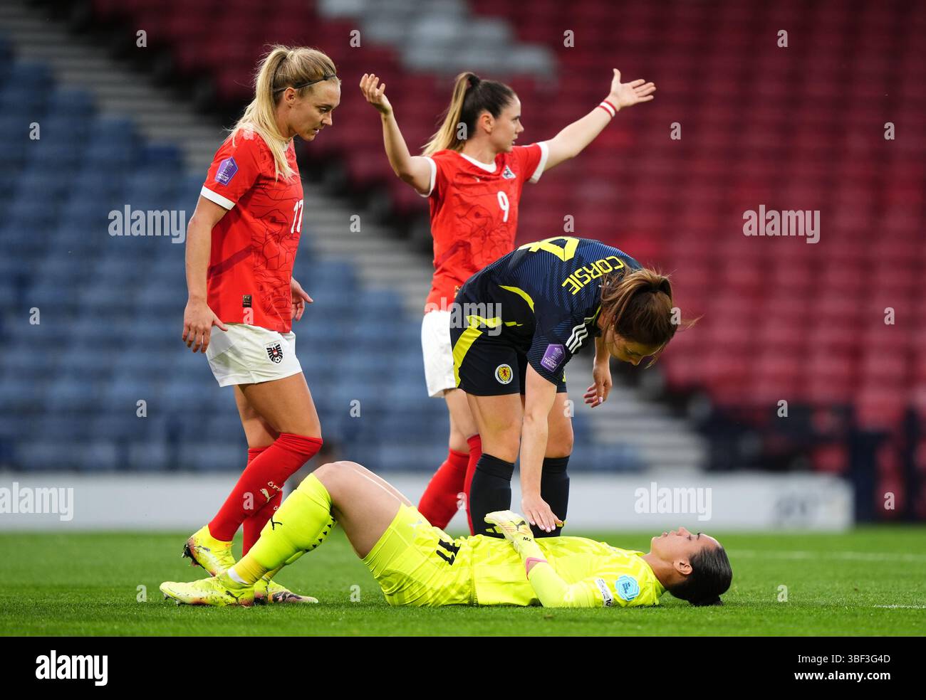 Scotland's Rachel Corsie helps up Austria goalkeeper Manuela Zinsberger ...