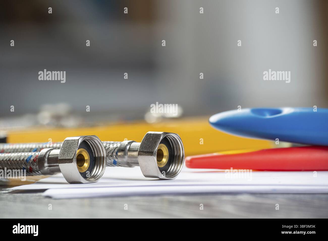 Water braided metal hose with connecting internal screw. Close up ...
