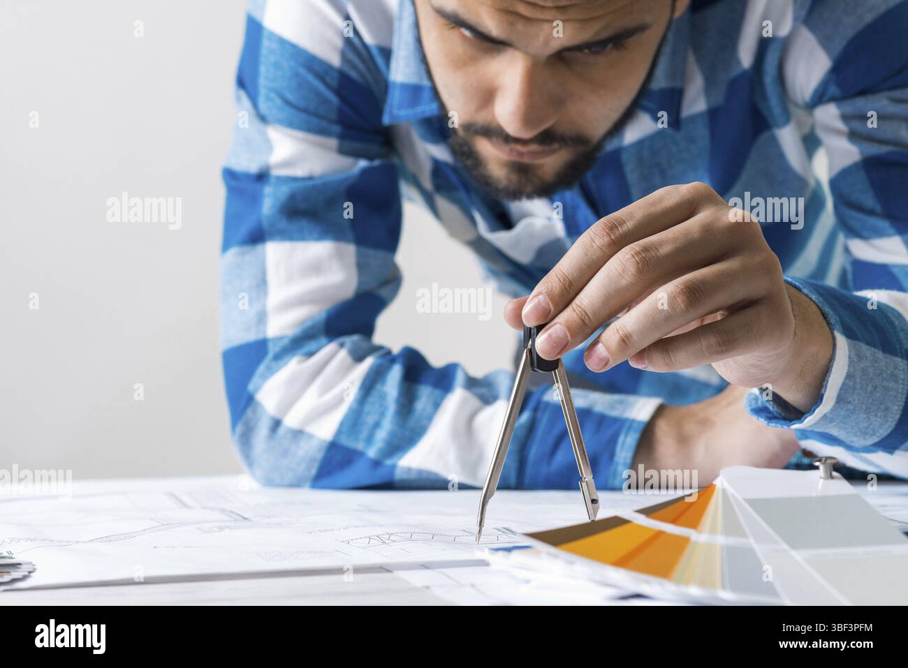 Man measuring with compass divider on construction blueprint. Architect ...