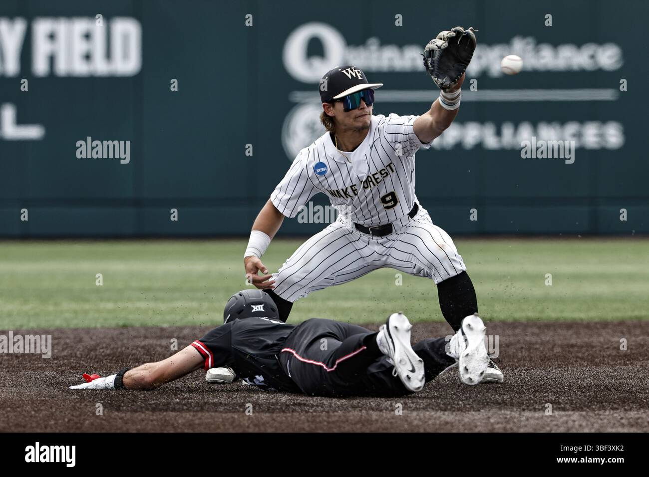 Wake Forest infielder Austin Hawke (9) takes a throw from the pitcher ...