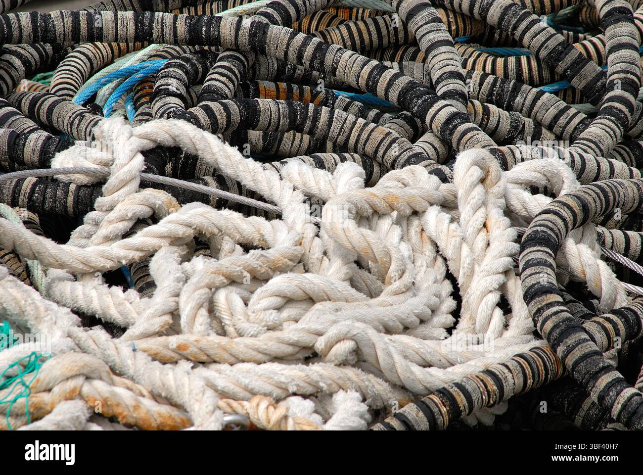 Close-up of a pile of various thick nautical ropes and hawsers ...