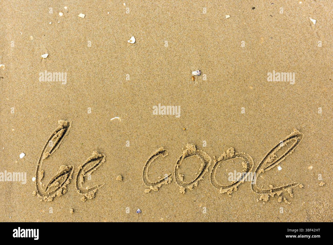 Be cool written on the beach. sand background Stock Photo - Alamy