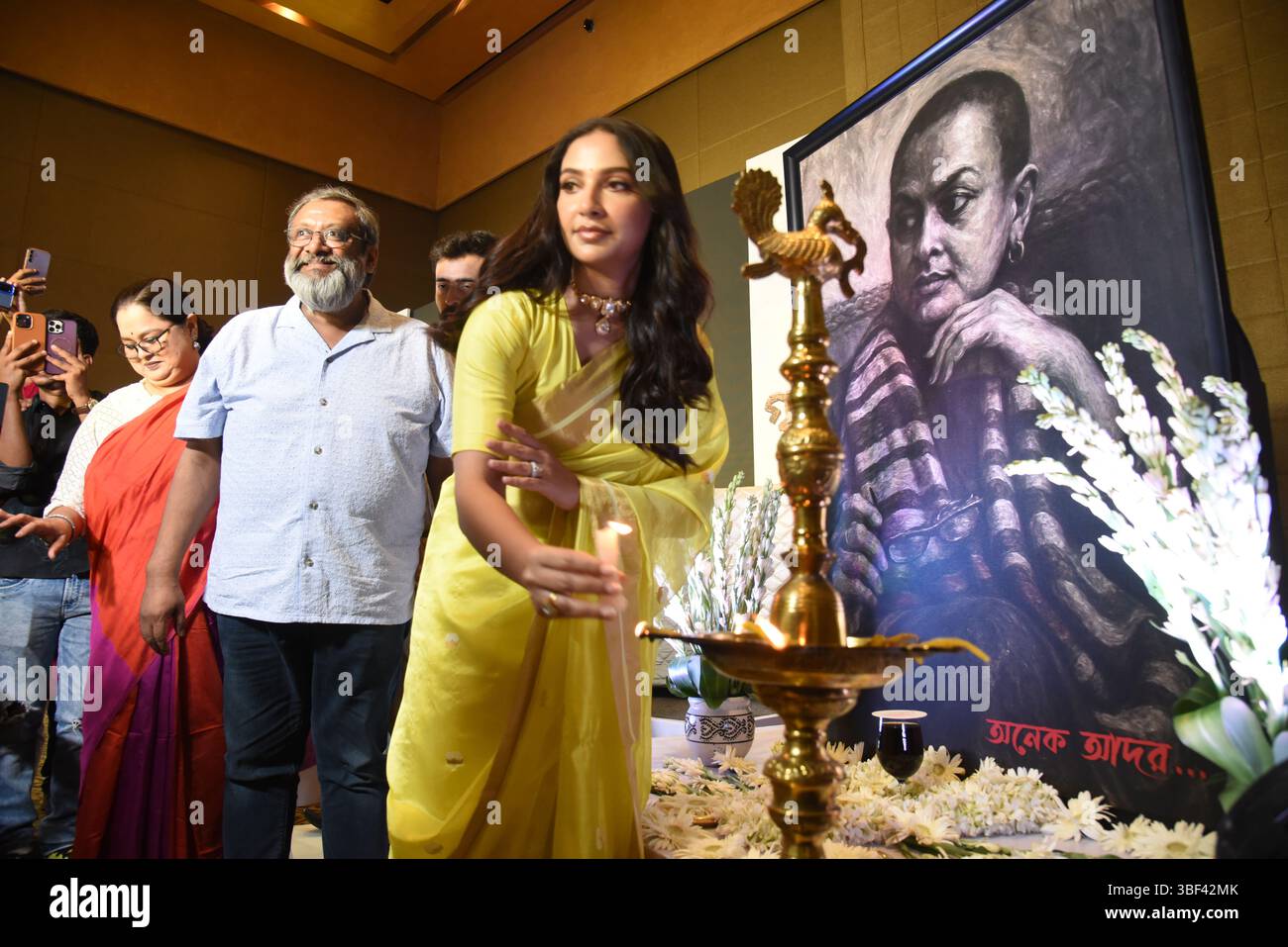 Actress Subhashree Ganguly lights a candle in front of the picture of Indian film director and ...