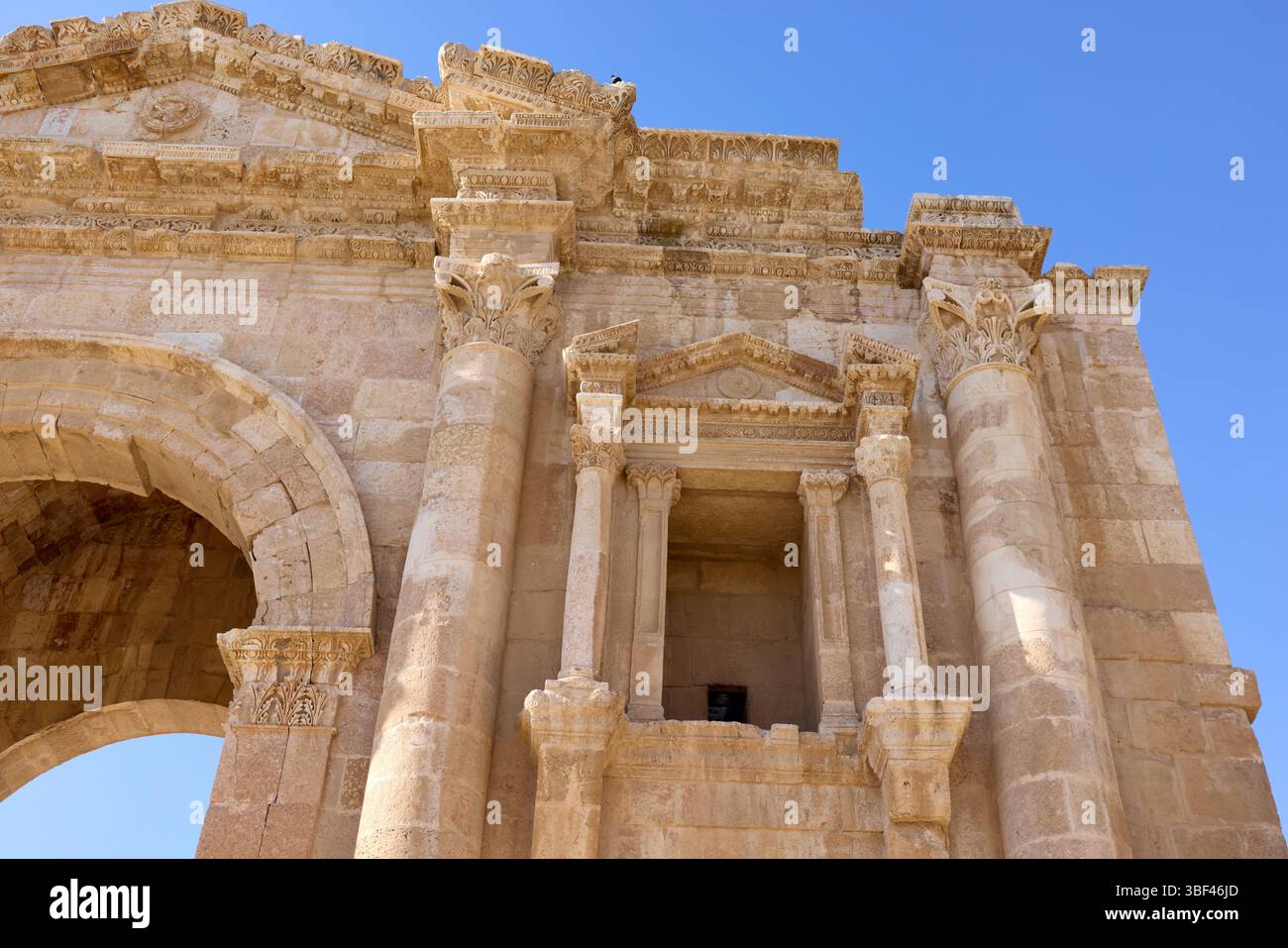 Visitors admire the intricate design of the Arch of Hadrian, a ...
