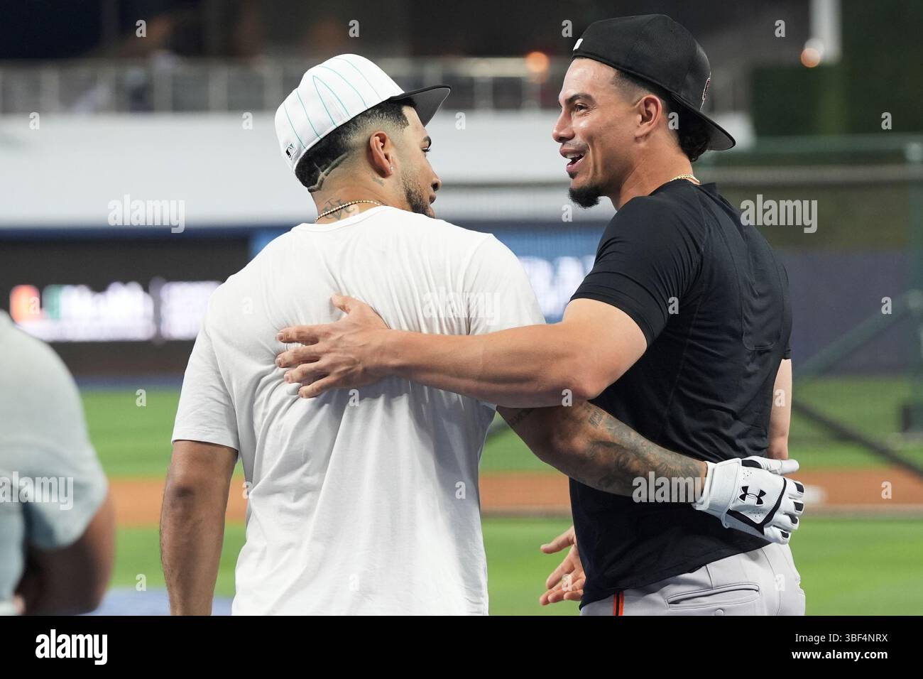 Miami Marlins' Victor Mesa Jr., left, talks with San Francisco Giants ...