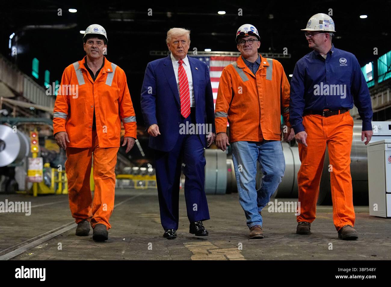 President Donald Trump walks with workers as he tours U.S. Steel ...