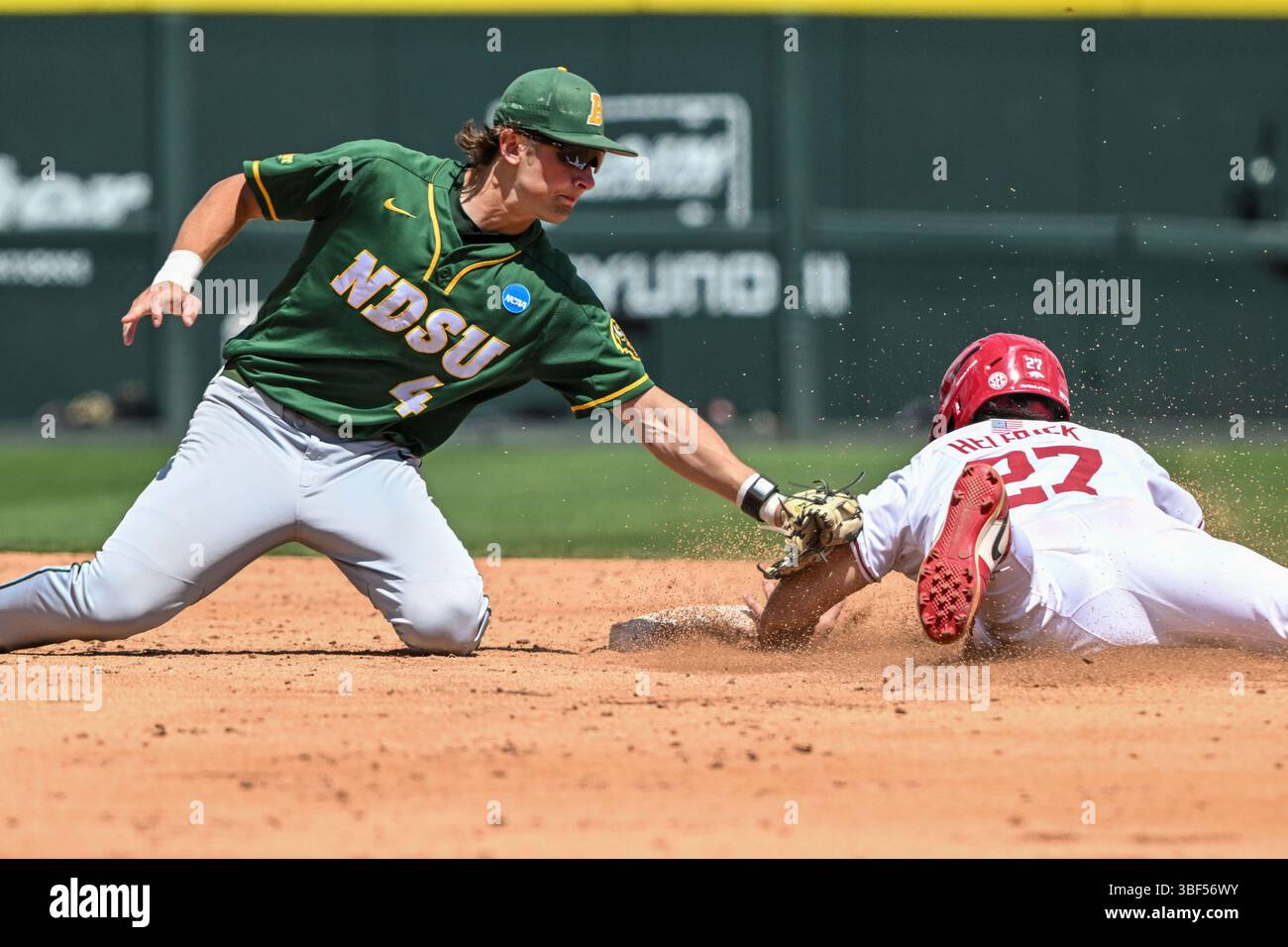 North Dakota State infielder Jake Schaffner (4) tries to put the tag on Arkansas baserunner ...