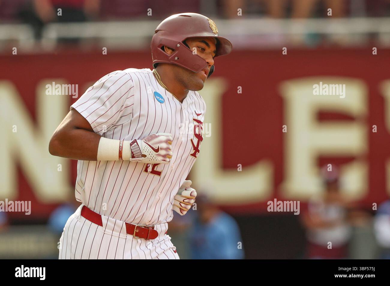 Florida State infielder Myles Bailey (12) rounds first base hitting a ...