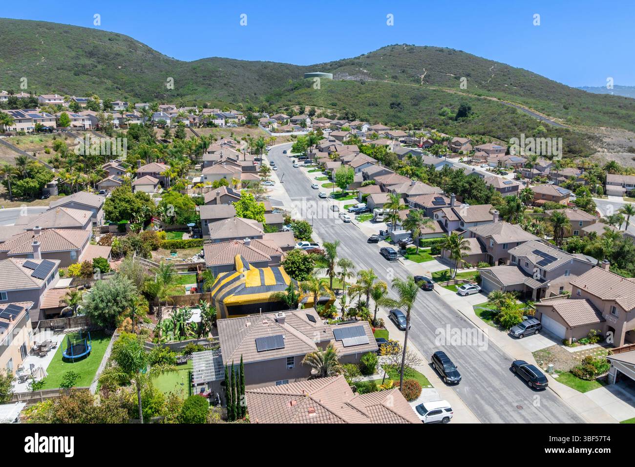 Aerial view of yellow and gray termite tent on a big house in San Diego ...