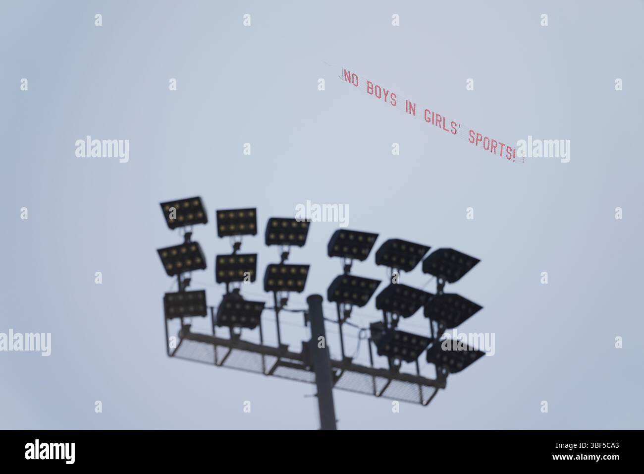 A banner reading "NO BOYS IN GIRLS' SPORTS!" is flown above Veteran's ...