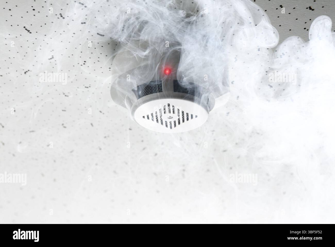 Fire alarm system. Detector on ceiling triggered by smoke Stock Photo ...