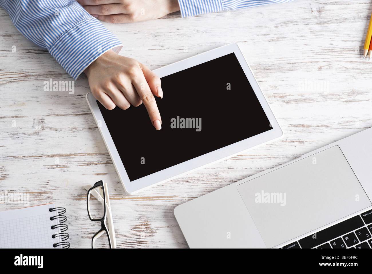 Business lady sitting at desk and using tablet computer. Corporate ...