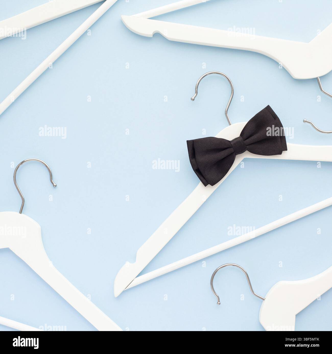 Creative top view flat lay white wooden hangers isolated pastel blue ...