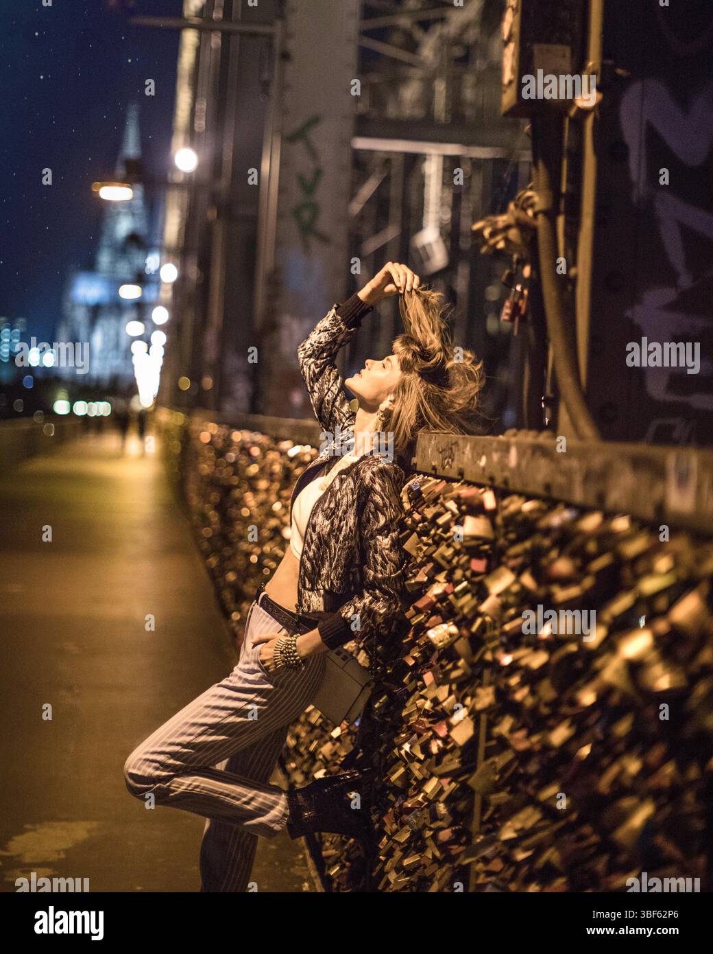 Portrait of attractive young woman lean against the fence full of love ...