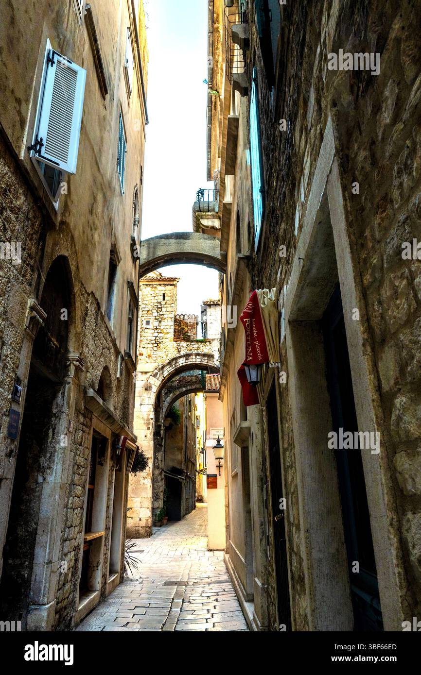 Old stone buildings and arched walkway in Split, Croatia Stock Photo ...