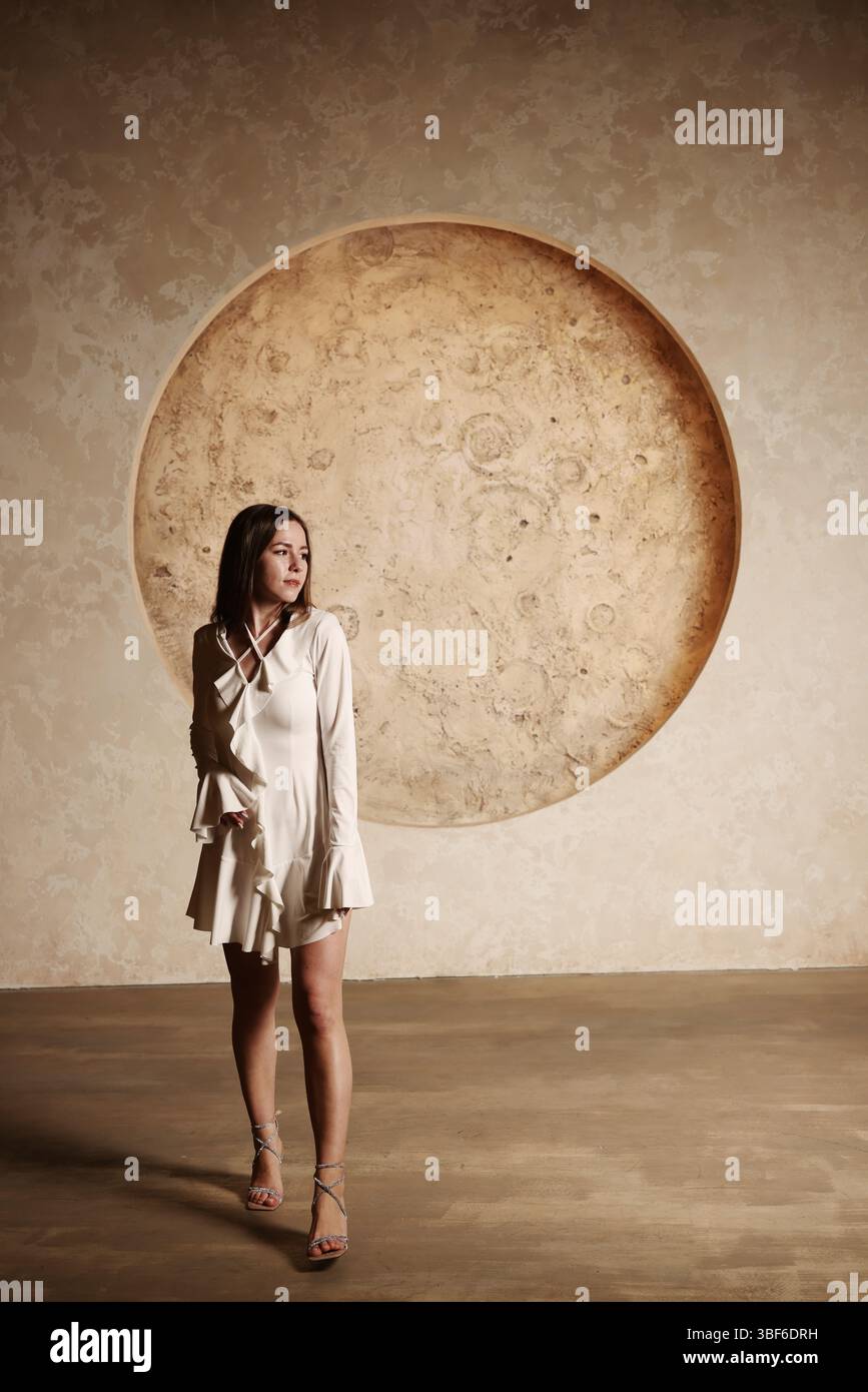 An Elegant Walk in a Minimalist Setting with a Bold Circular Backdrop ...