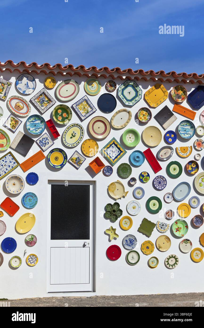 Traditional portuguese pottery plates on a wall in Algarve Coast ...