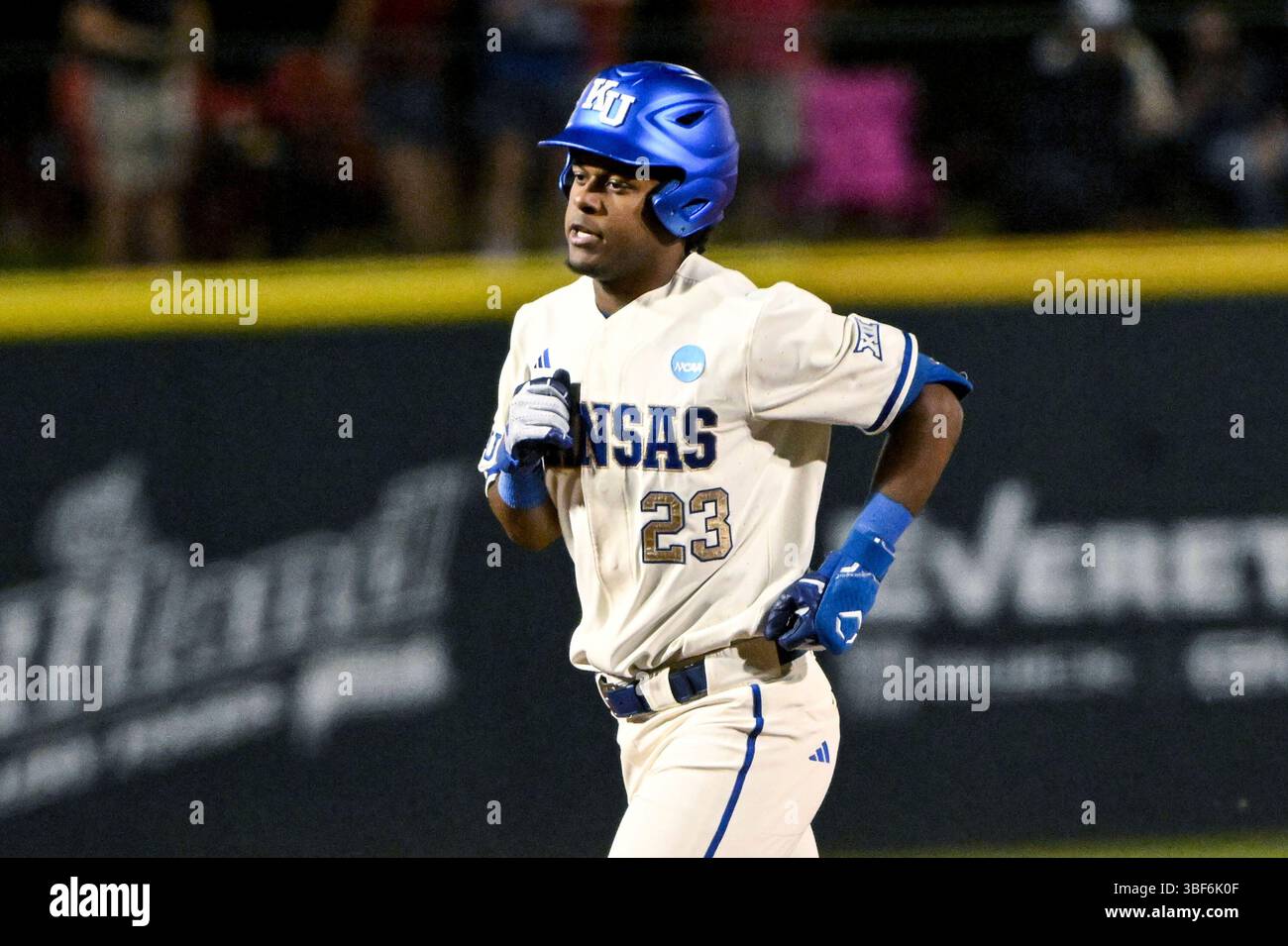 Kansas batter Dariel Osoria (23) rounds the basses after hitting a home ...