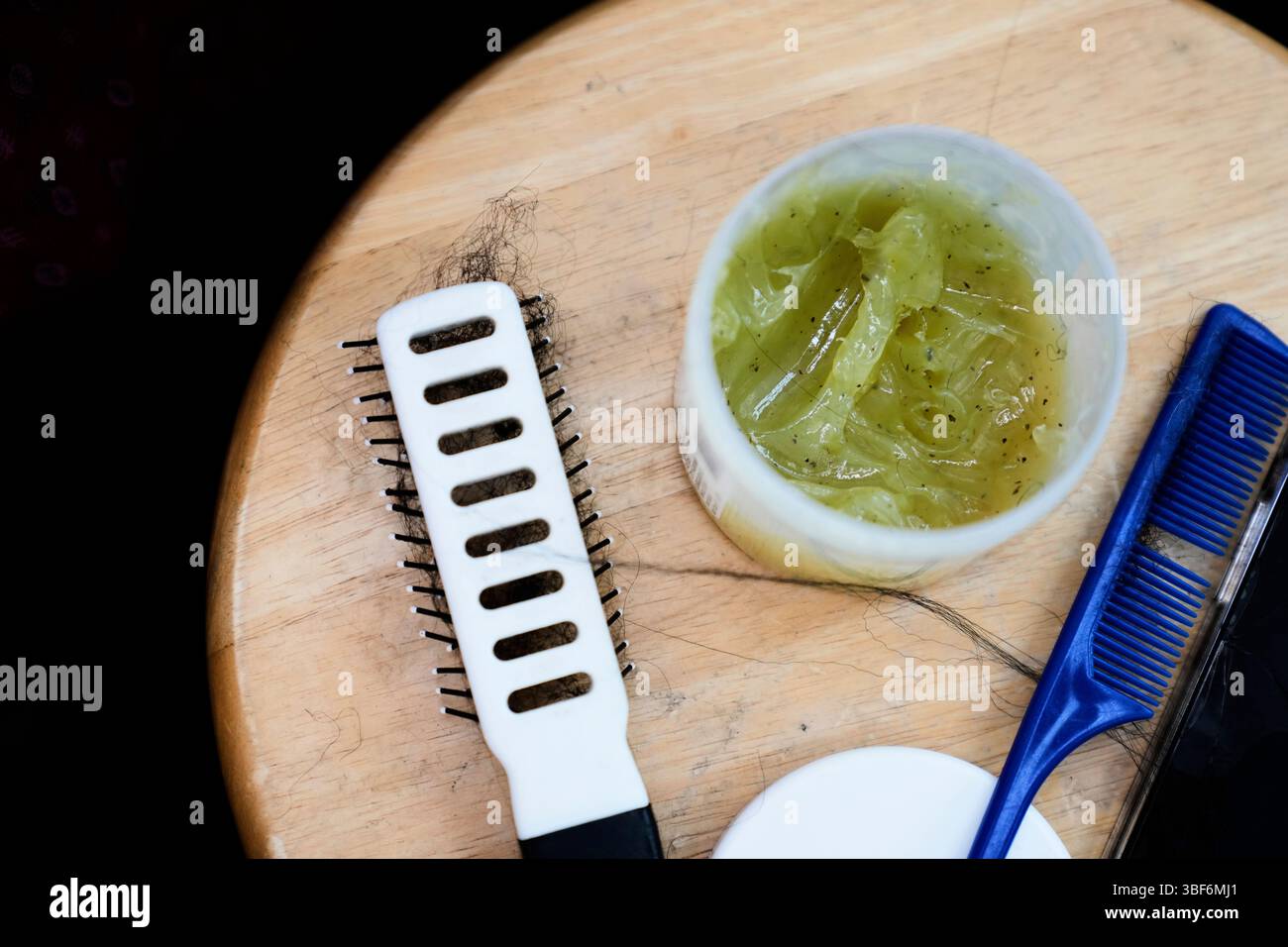 Braiding grease is seen next to a brush and comb at Eve's African ...