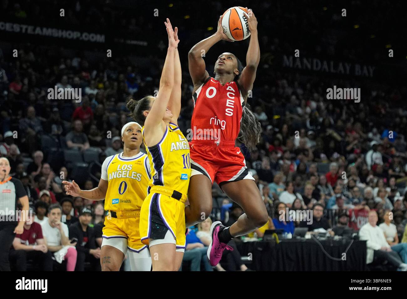 Las Vegas Aces guard Jackie Young (0) shoots over Los Angeles Sparks ...