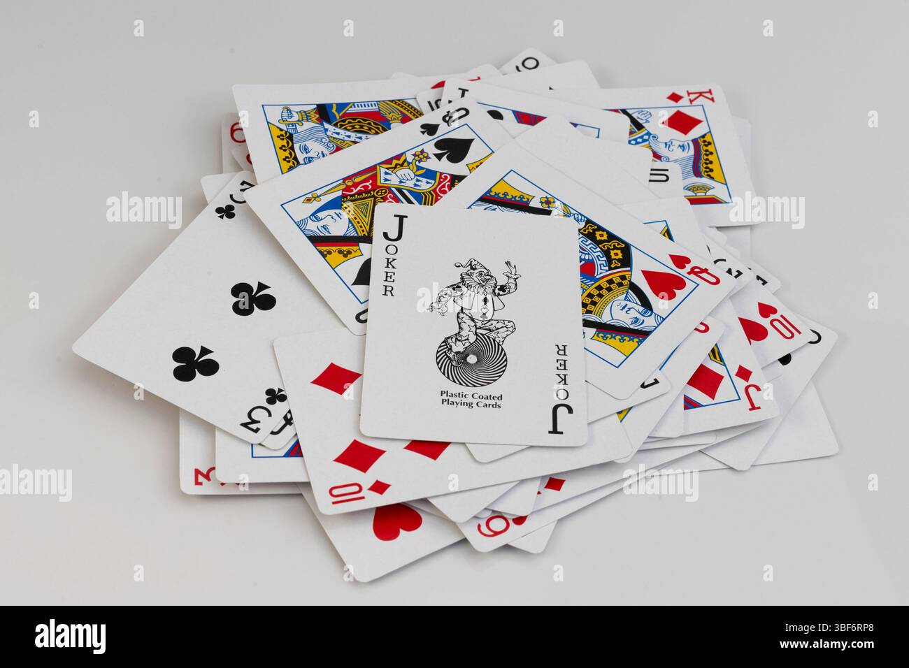 Joker on top of a playing cards pile. Casino gaming theme Stock Photo ...
