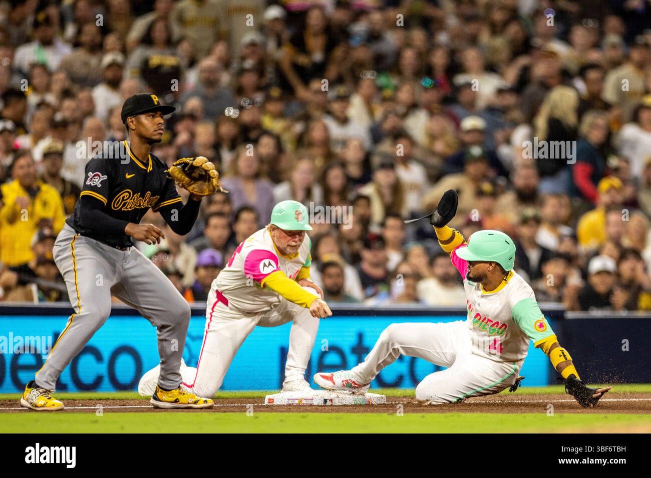 San Diego Padres third base coach Tim Leiper, center, points at Luis ...