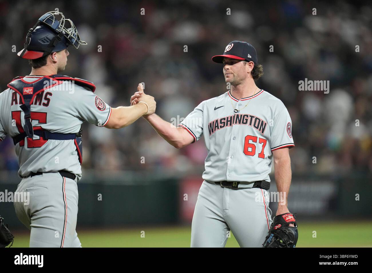 Washington Nationals pitcher Kyle Finnegan (67) slaps hands with ...