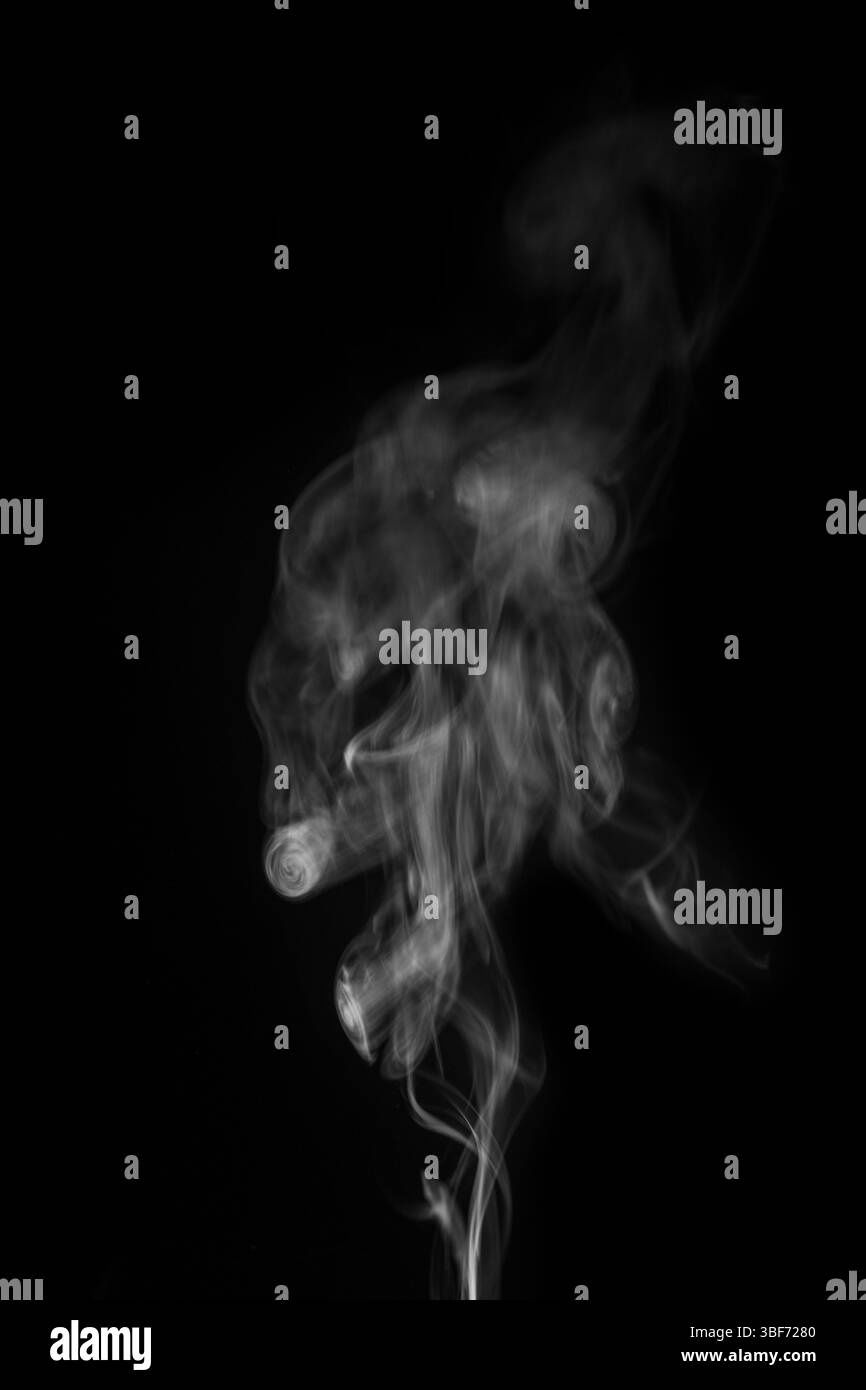 Ethereal wisps of smoke swirling gracefully against a dark background ...