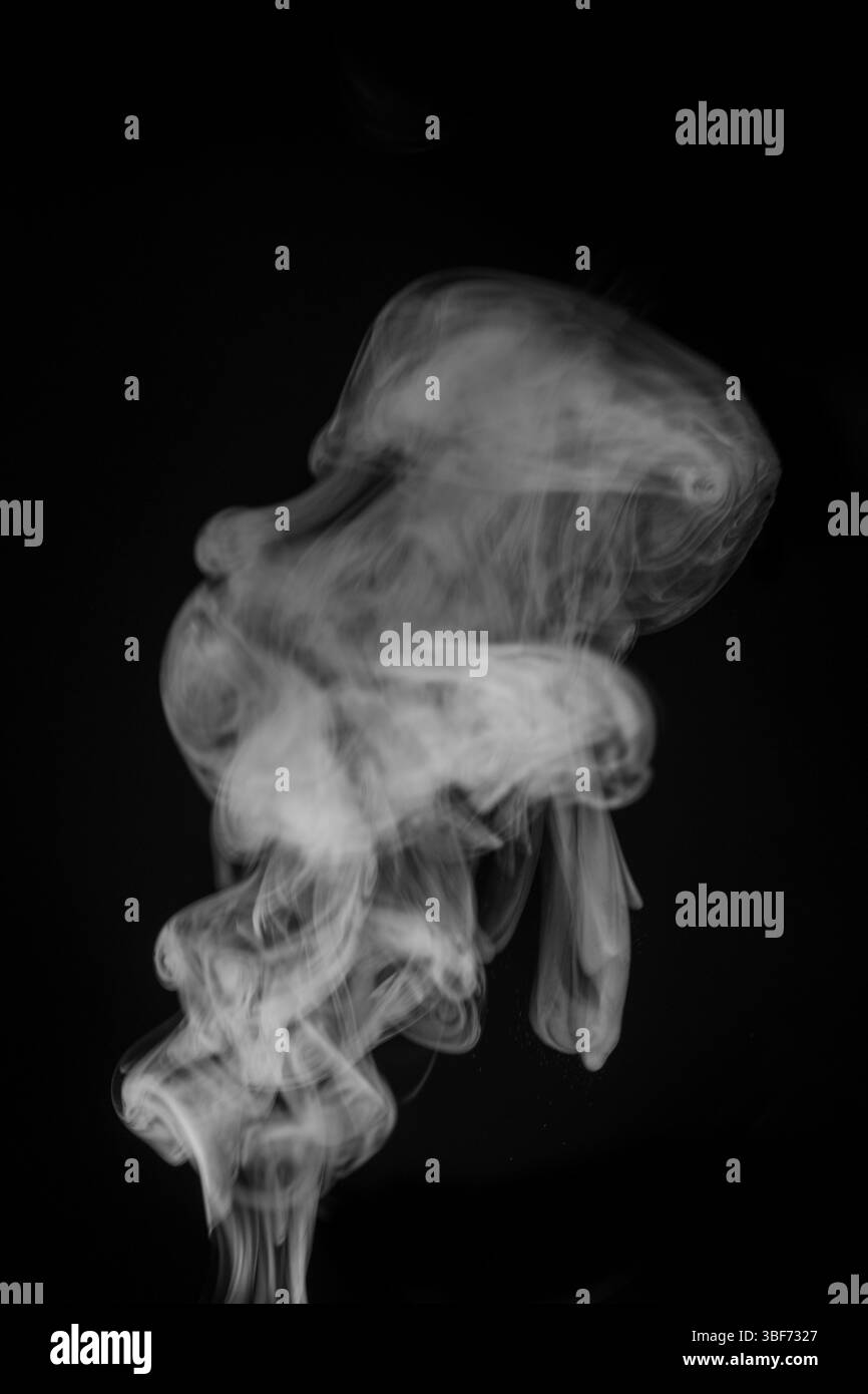 Ethereal wisps of smoke swirling gracefully against a dark backdrop ...