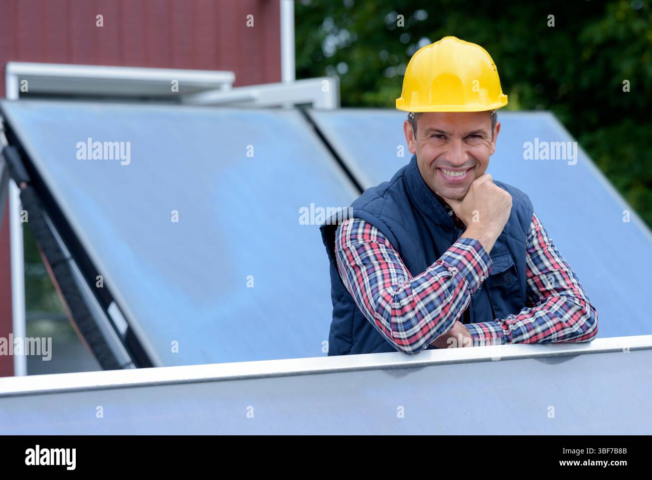 happy builder with solar panels Stock Photo - Alamy