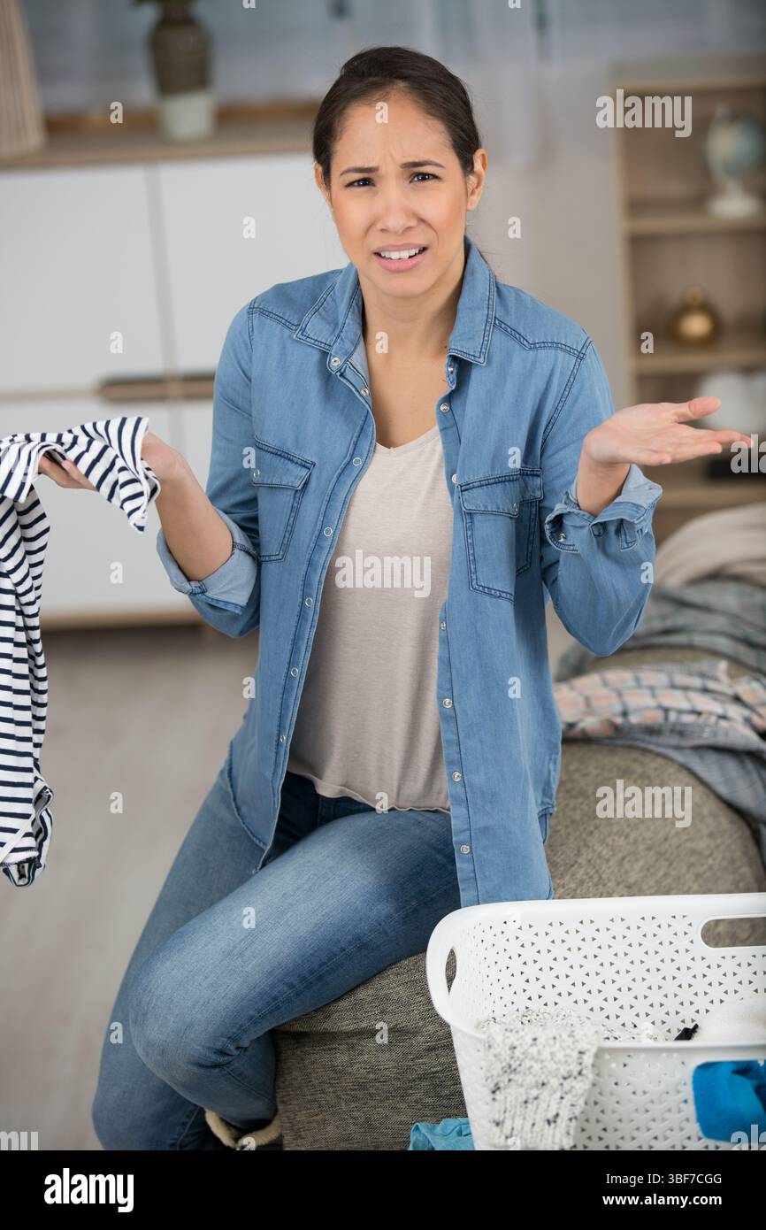 sleepy bored woman lying on ironing board Stock Photo - Alamy