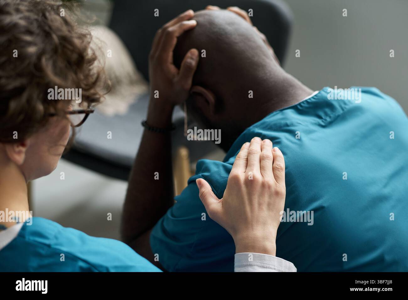 Medical professional comforting colleague during a challenging moment ...