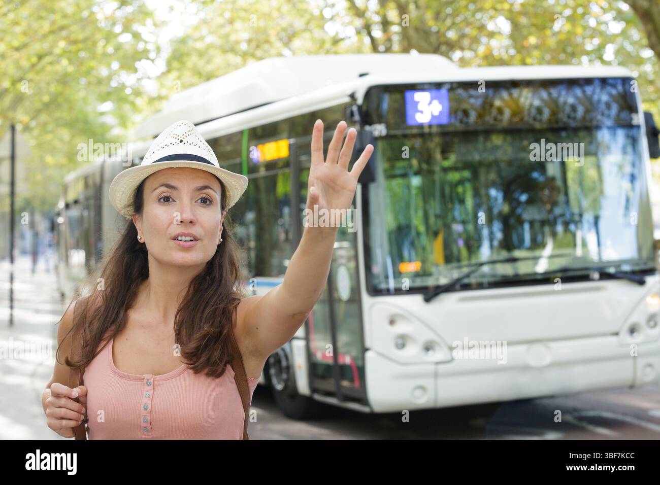 female tourist hailing a bus Stock Photo - Alamy