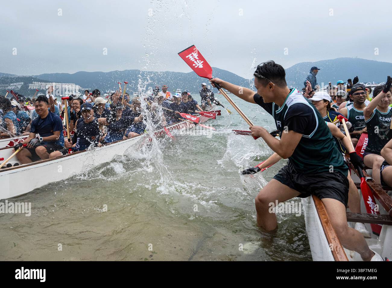 Competitors cheer and celebrate after the race in the Stanley International Dragon Boat ...