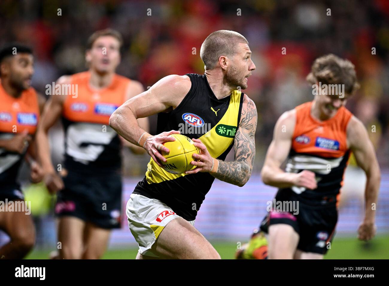 Nathan Broad of the Tigers controls the ball during the AFL Round 12 ...